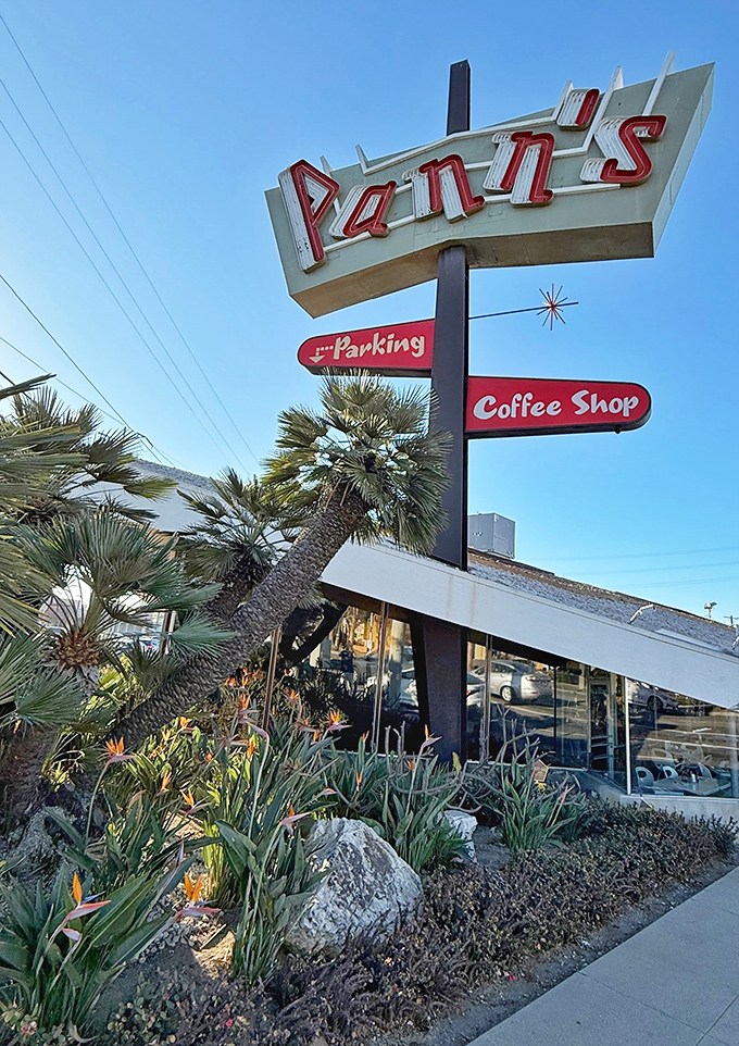 The Pann's sign stands tall against blue California skies. A neon beacon guiding hungry travelers to breakfast salvation since the Eisenhower administration.