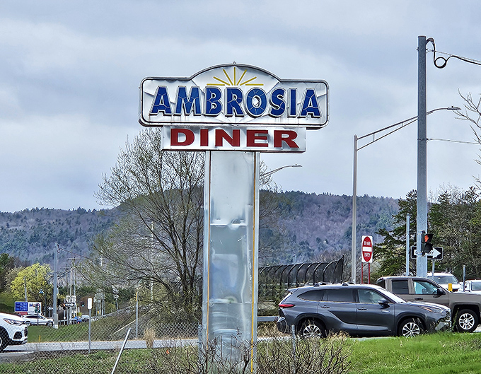 The roadside sign stands tall against Adirondack foothills, a beacon of hope for hungry travelers who've had quite enough of chain restaurant mediocrity.