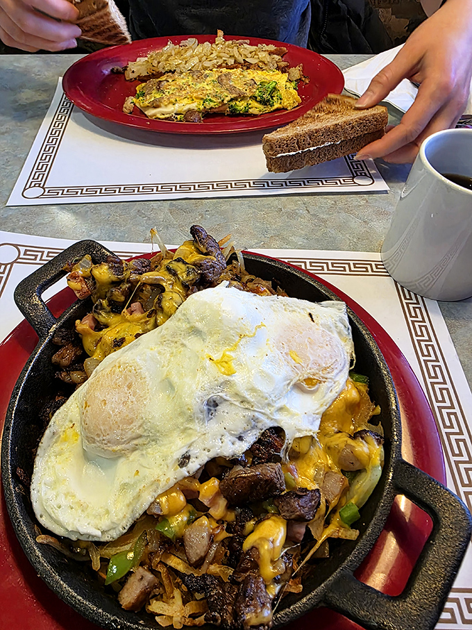 The breakfast skillet: where eggs, potatoes, veggies and cheese gather for the morning's most important meeting. That sunny-side up egg is the chairperson.