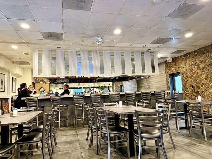 Where culinary magic happens&mdash;a glimpse into the diner's heart, where staff orchestrate the breakfast ballet that keeps locals coming back decade after decade. 