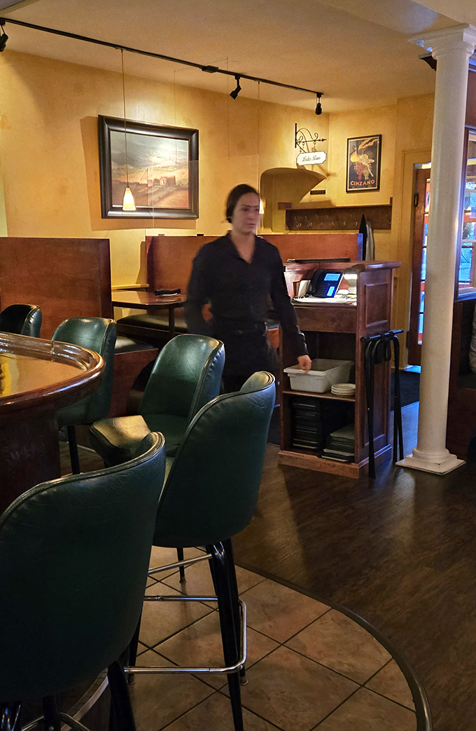 The warm amber interior creates a stage where staff orchestrate the nightly performance of exceptional Italian dining.