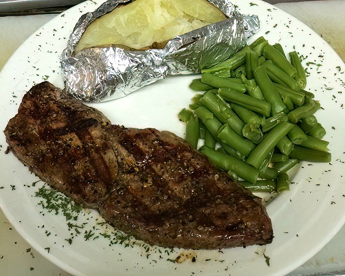 Sometimes the simplest plate tells the most honest story&mdash;a perfectly cooked steak, green beans, and a foil-wrapped potato waiting to be discovered.