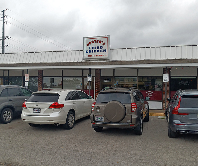 The parking lot that's rarely empty. Cars gather like hungry pilgrims at this shrine to fried chicken excellence.