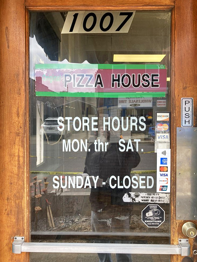 Hours posted with no-nonsense clarity. Closed Sundays because even pizza legends need a day of rest.