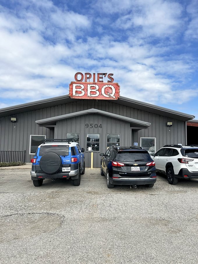 The view that makes your stomach growl before you even park. That sign against the clouds is practically a Texas landmark.