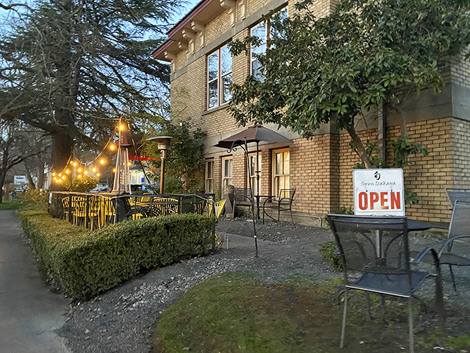 As evening falls, string lights transform the storefront into a magical dining destination worth driving hours to find.