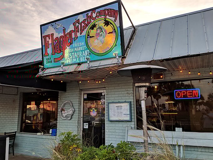 The aqua exterior glows at dusk, a beacon for hungry travelers. This little seafood shack has serious culinary ambitions.