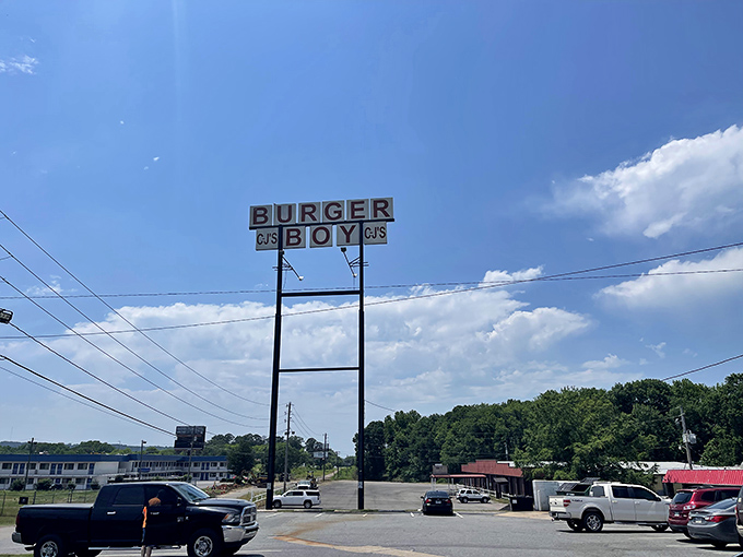The vintage sign reaches skyward, a roadside promise that burger nirvana awaits just beyond the parking lot.