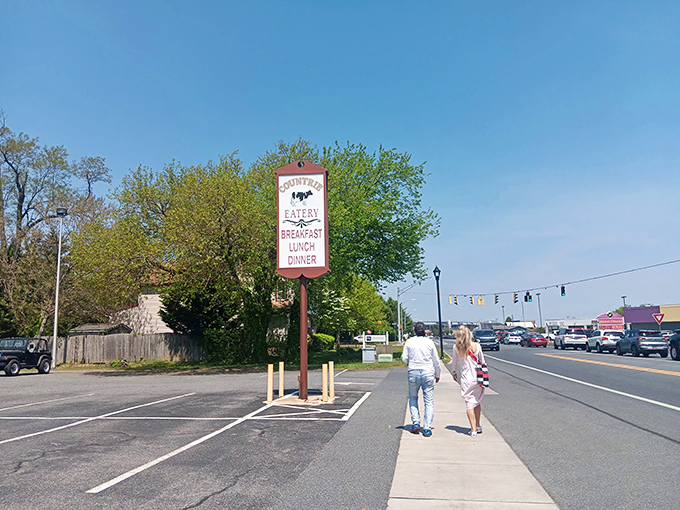 The sign that locals follow like a North Star. Two people walking toward breakfast happiness—a journey worth taking any day of the week.