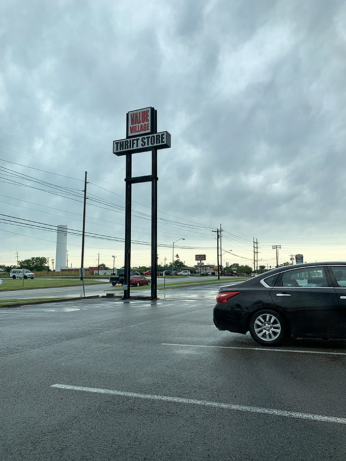 The towering sign stands sentinel in the Oklahoma sky, beckoning bargain hunters like a lighthouse for the fiscally responsible.