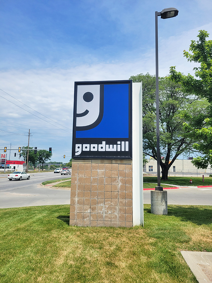 The iconic Goodwill smile sign stands sentinel at the parking lot entrance, a beacon for bargain hunters and sustainability champions alike.