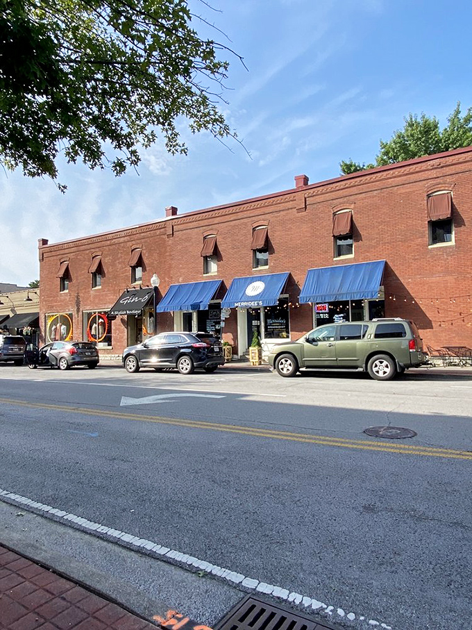 The brick storefront stands as a testament to timeless appeal. Those blue awnings have sheltered more food pilgrimages than most travel guides.