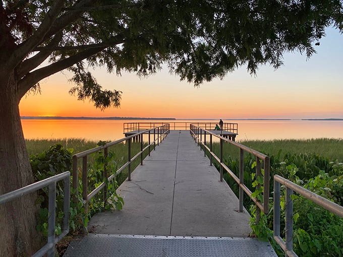 A lone figure contemplates the sunset from a lakeside pier &ndash; some moments in Leesburg are worth a million words but cost absolutely nothing.