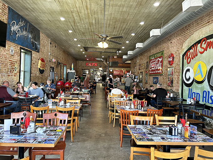 The long dining room stretches back with exposed brick and vintage signs, creating an atmosphere where strangers become breakfast buddies naturally.