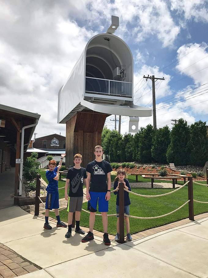 Families create lasting memories beneath this towering testament to everyday objects made extraordinary. "Stand tall," the mailbox seems to whisper, "and dream bigger." 