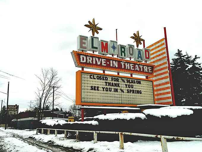 Even in winter slumber under a blanket of snow, the Elm Road sign promises springtime returns of starlit stories and buttery popcorn nights.