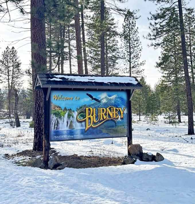 Winter transforms Burney into a snow globe scene. Even in the coldest months, the welcome sign promises the falls continue their eternal performance.