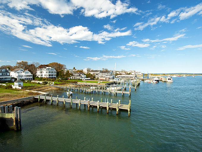 Weathered docks stretch into crystal waters like fingers reaching toward endless summer possibilities.
