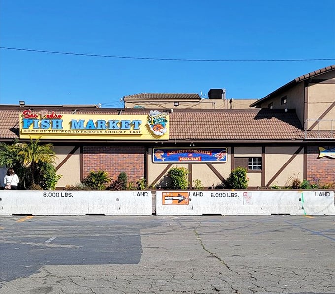 San Pedro's seafood palace where industrial charm meets family-style portions that could feed a small fishing village.