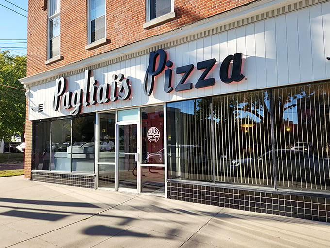 The classic storefront of Pagliai's Pizza beckons like an old friend. That vintage sign promises pizza perfection waiting just inside.