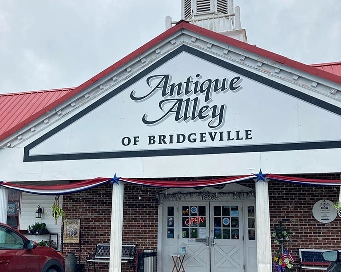 The classic red-roofed charm of Antique Alley beckons treasure hunters like a time portal disguised as a friendly country store.