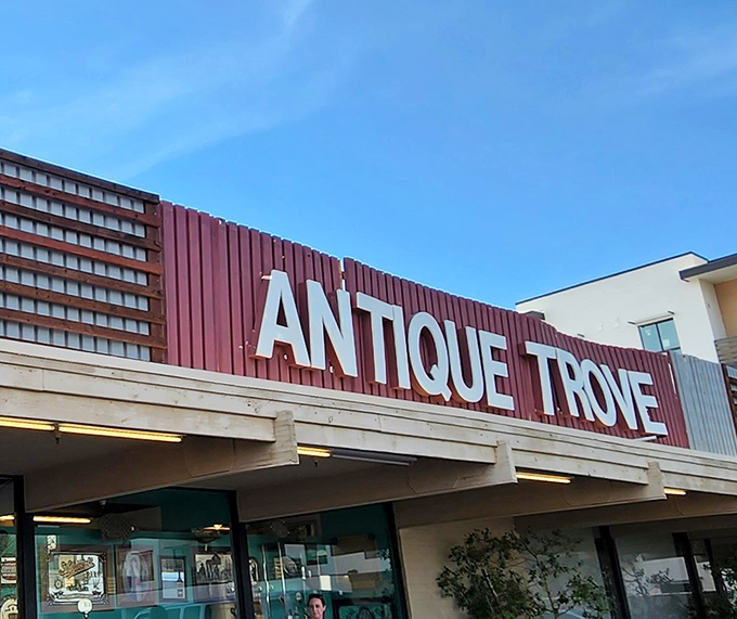 That classic red and white sign promises treasures inside - like a vintage Vegas marquee for antique lovers.