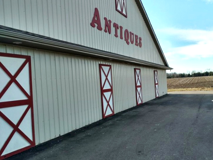 The barn-red trim against white walls isn't just eye-catching&mdash;it's practically shouting "treasures inside!" at passing antiquers.