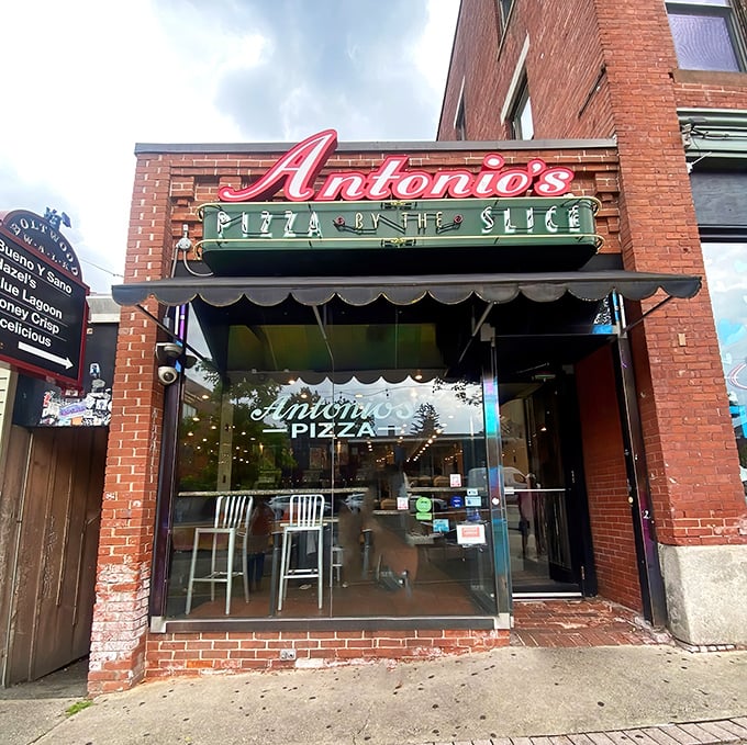 Antonio's storefront beckons with its classic neon sign. Pizza by the slice never looked so inviting!