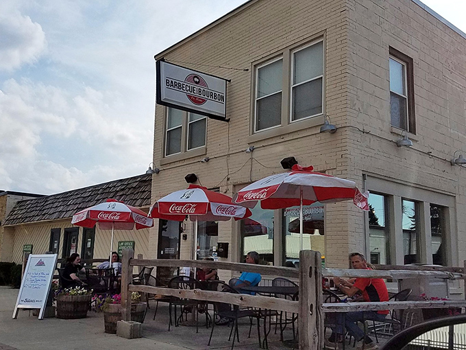 The classic brick exterior of Barbecue and Bourbon promises smoky treasures inside. Those Coca-Cola umbrellas aren't just for show &ndash; they're inviting you to stay awhile!