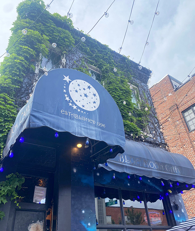 The Blue Moon Cafe's ivy-covered exterior and blue awning create a secret garden vibe in Baltimore's bustling streets.