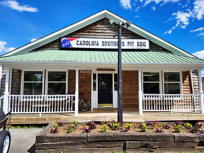 That green roof and welcoming porch whisper "come hungry, leave happy" in the universal language of barbecue.