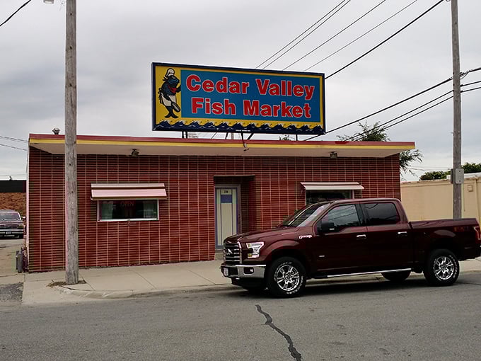The bright sign of Cedar Valley Fish Market promises seafood treasures hiding behind that unassuming brick facade.
