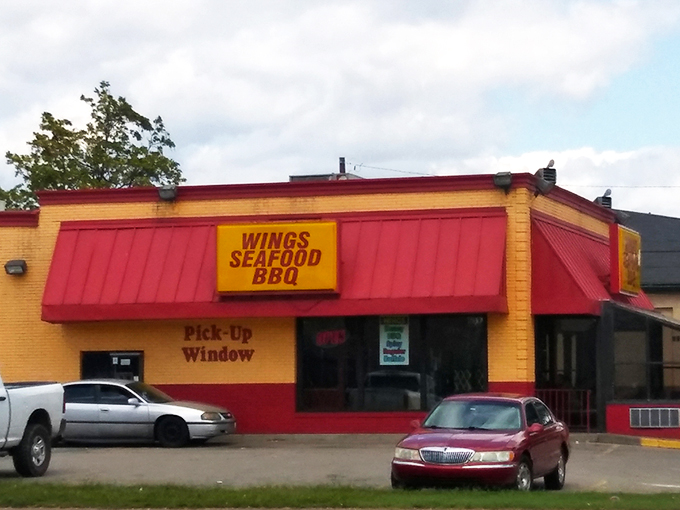 Chicken King's vibrant yellow and red building stands out like a beacon for hungry travelers. The pick-up window promises fast service for crispy delights.