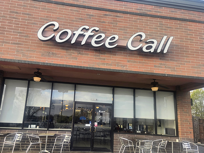 That brick facade whispers "serious coffee lives here" - and those windows promise warmth inside.