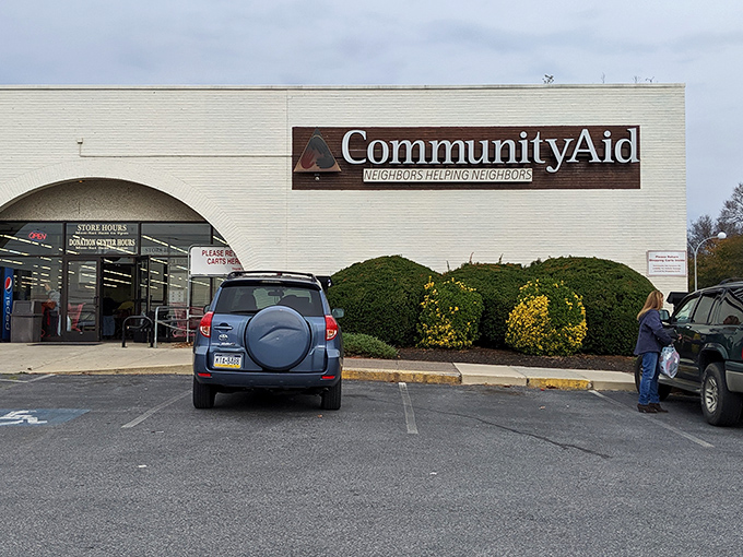The welcoming facade of Community Aid, where treasure hunting begins and your wallet breathes a sigh of relief.