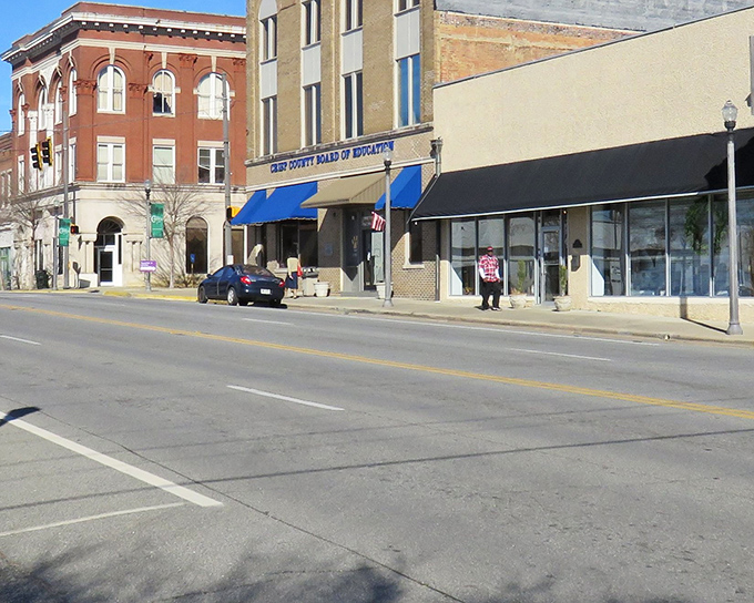 Downtown Cordele's historic brick buildings stand like sentinels of simpler times, where blue awnings offer shade and stories.