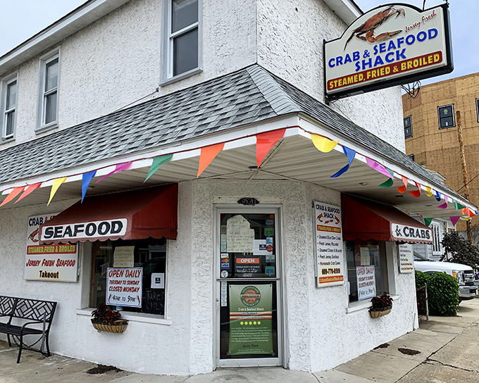 Those colorful flags aren't just decoration - they're practically waving you toward some seriously good crab action inside this cheerful Wildwood gem.