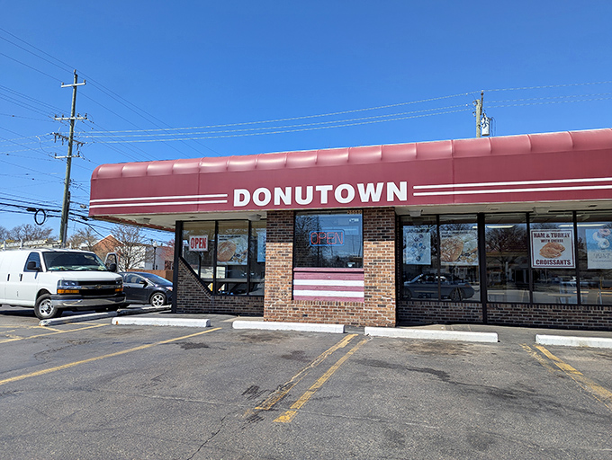 The iconic red awning of Donutown beckons like a sweet siren call to morning commuters on 5 Mile Road.