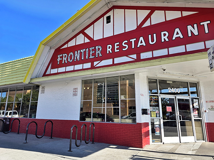 The iconic red-trimmed Frontier Restaurant sign welcomes hungry patrons like a beacon of breakfast hope in Albuquerque.