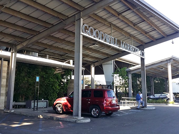 The Goodwill Marketplace entrance beckons like a cathedral of secondhand treasures. That covered walkway practically whispers, "Come find your bargain bliss."