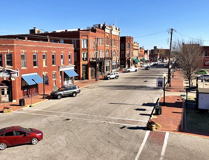Guthrie's red brick downtown stretches like a perfectly preserved movie set where every building tells a story.