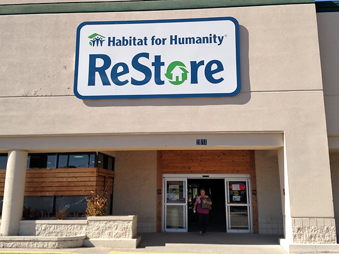 The Habitat ReStore sign beckons like a beacon of hope. Where your furniture shopping becomes someone else's new beginning.