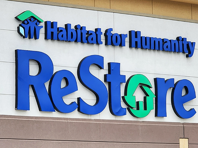 The iconic blue and green Habitat ReStore sign&mdash;where your furniture shopping funds someone's future home.