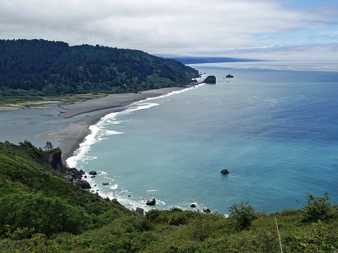 Hidden Beach stretches along Klamath's coastline like nature's secret masterpiece, where forest-covered hills meet the endless Pacific.