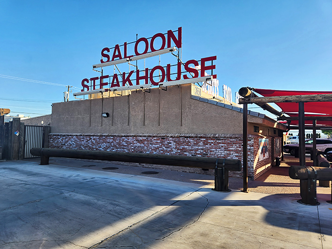 The iconic Hitchin' Post sign stands tall against the Nevada sky, promising cowboy-sized steaks and old-west charm.