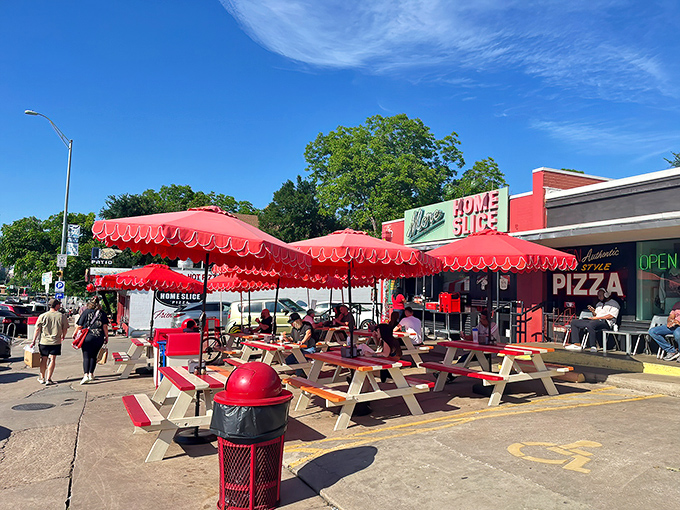 Home Slice's red awnings and picnic tables create the perfect urban oasis. Pizza paradise found in the heart of Austin!