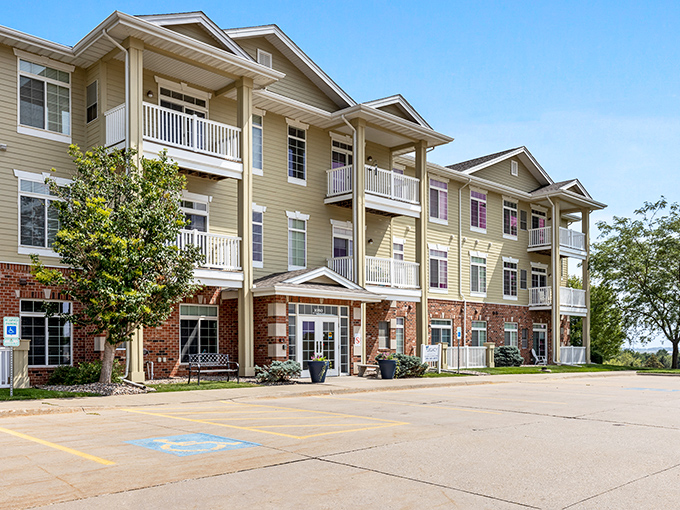 Legacy Senior Living's welcoming fa&ccedil;ade combines brick and tan siding, creating a homey atmosphere where retirement dreams bloom.
