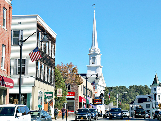 Main Street magic unfolds where white church spires pierce blue skies like exclamation points of pure New England charm.