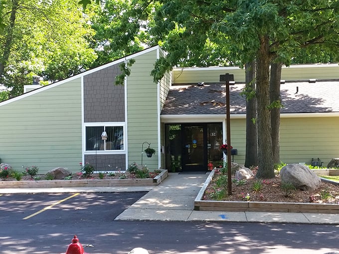 The welcoming entrance of Mill Pond Manor, where nature and comfort meet without sending your wallet into shock therapy.