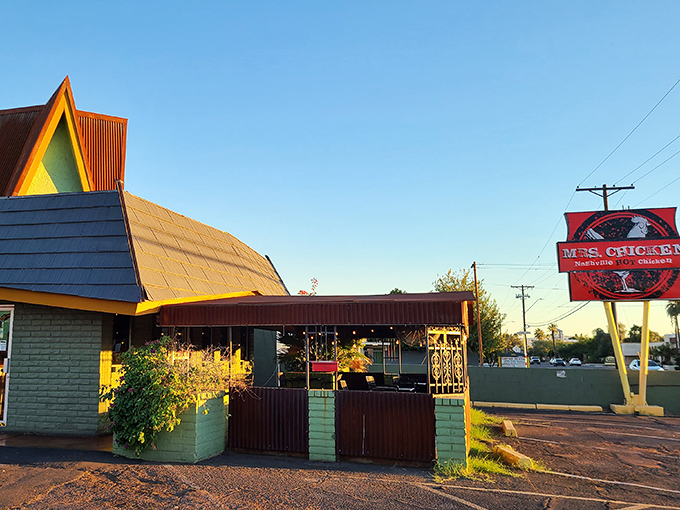 The iconic A-frame of Mrs. Chicken beckons like a mint-green lighthouse guiding hungry souls to crispy salvation.